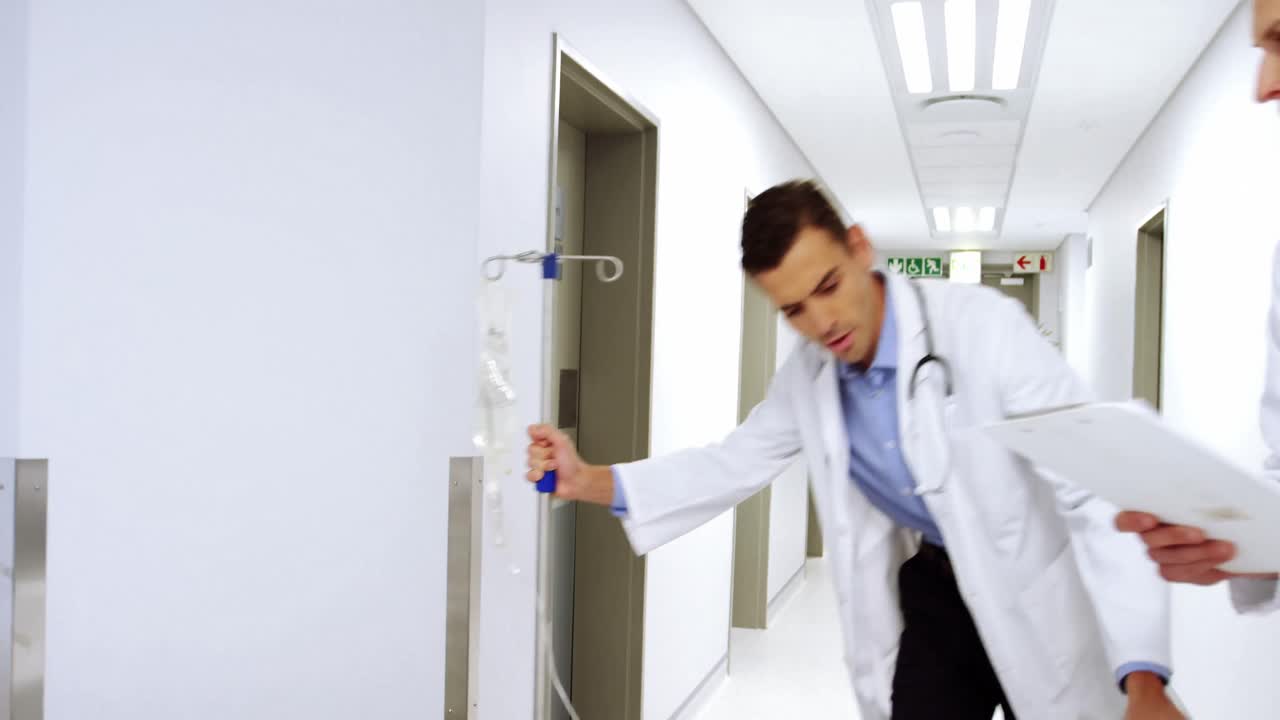 Doctors pushing emergency stretcher bed in corridor Free Stock Video ...