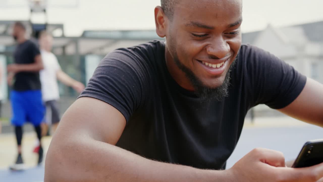 Basketball player using mobile phone 4k | วิดีโอสต็อกแบบ พรีเมี่ยม