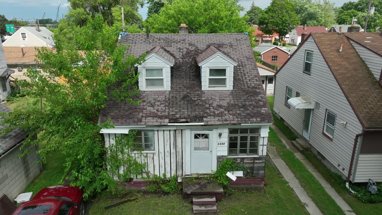 Premium stock video - Rundown house with falling apart shingles on roof