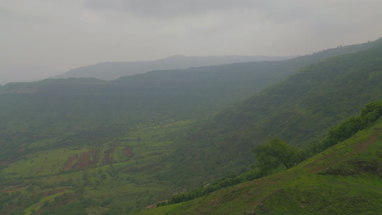 A drone glides over the lush green mountains of Panchgani, Maharashtra ...