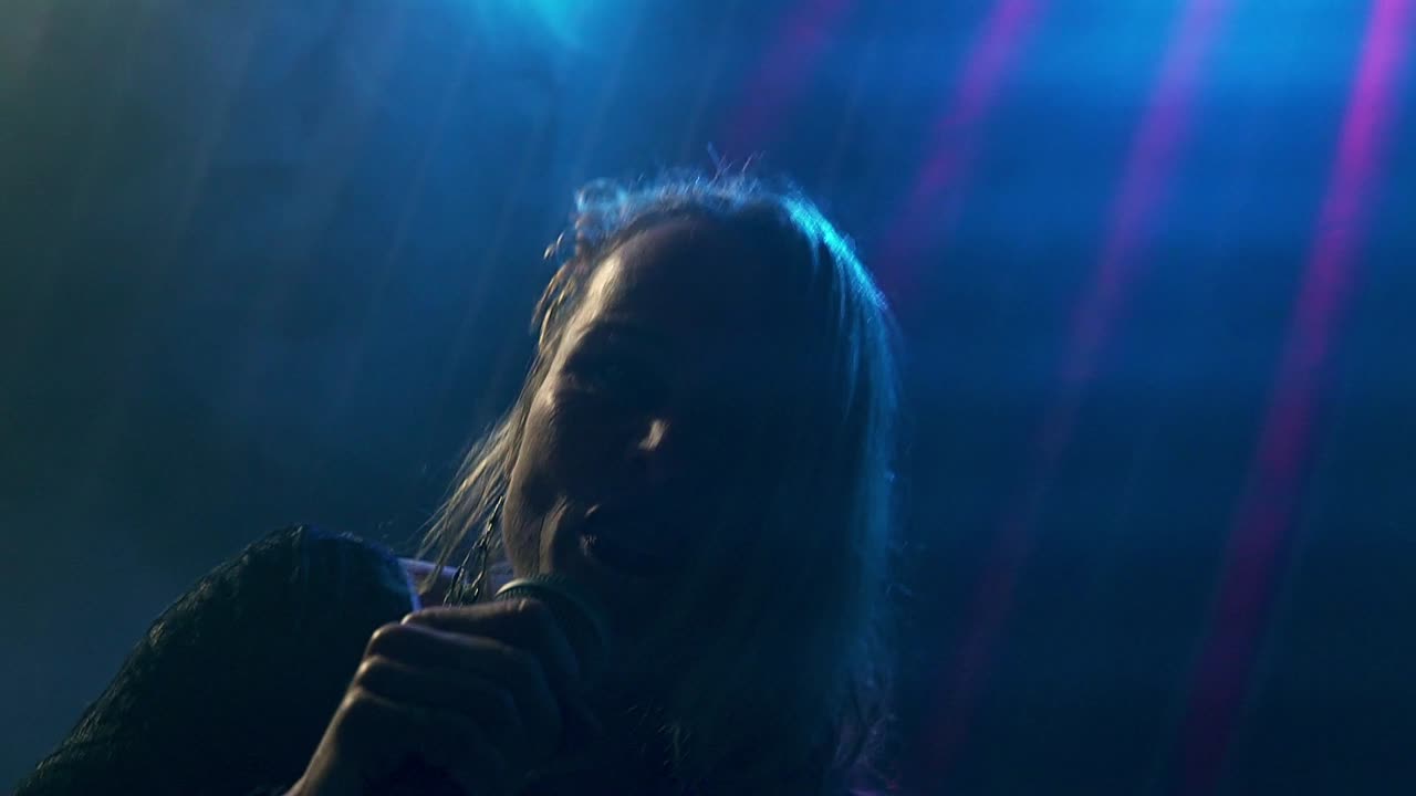 Handheld Medium Shot Of A Blonde Talented Singer During A Concert ...