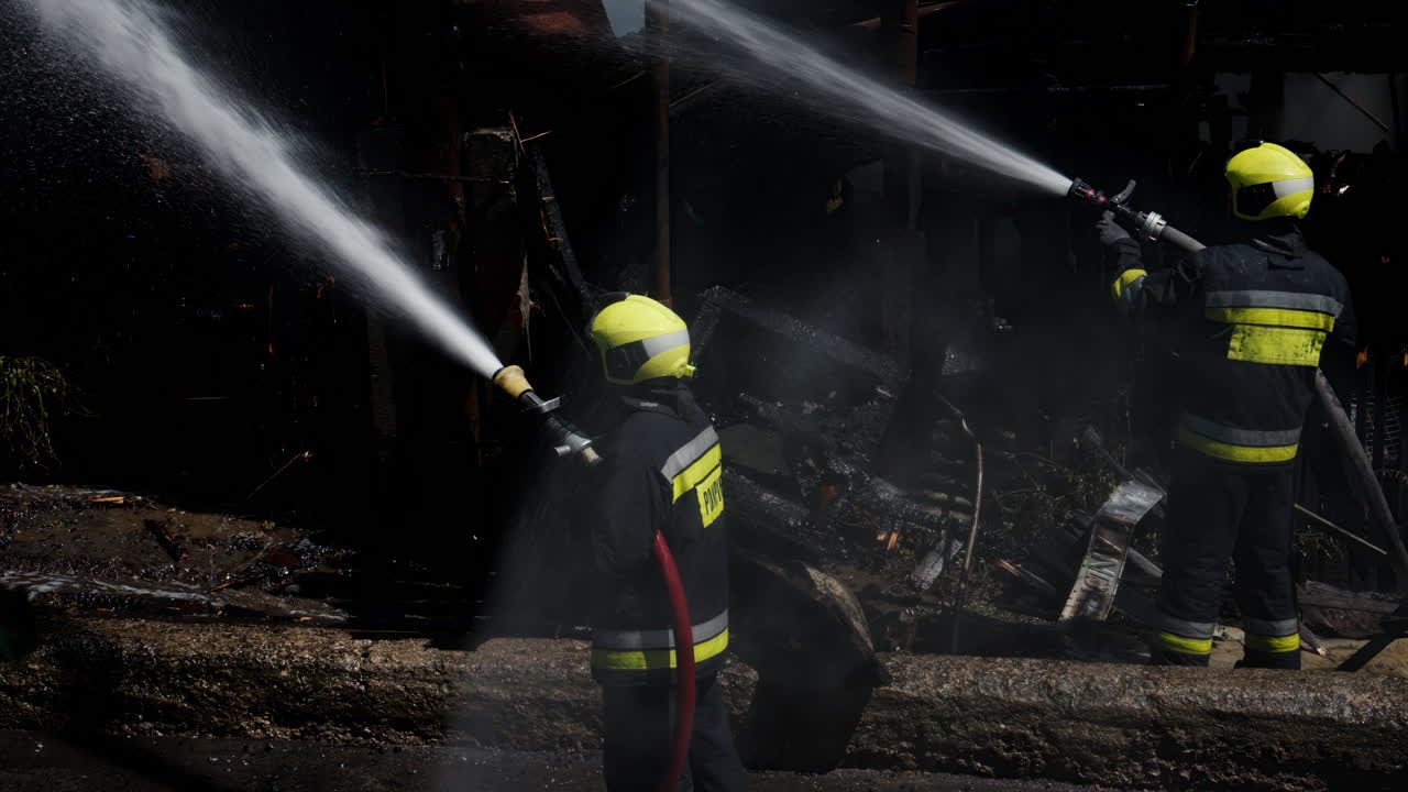 Firefighters trying to extinguish a house on fire | Premium Stock Video ...