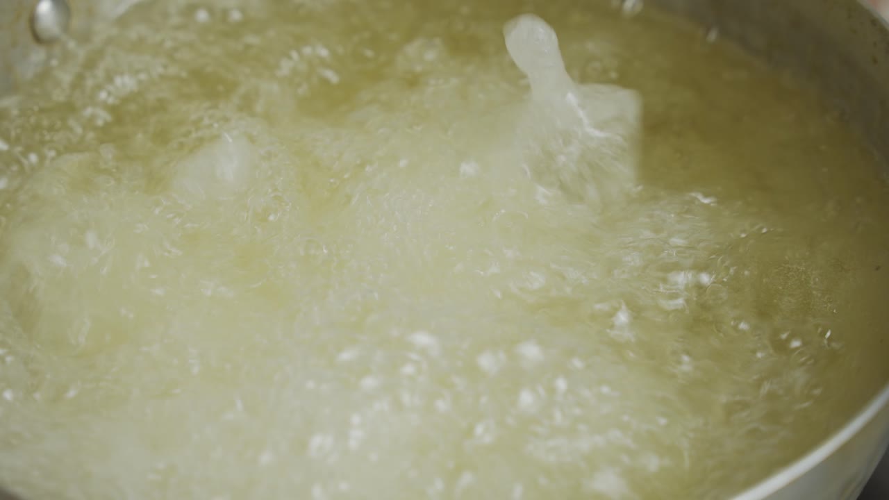 Putting marinated chicken meat inside hot boiling oil | Premium Stock ...