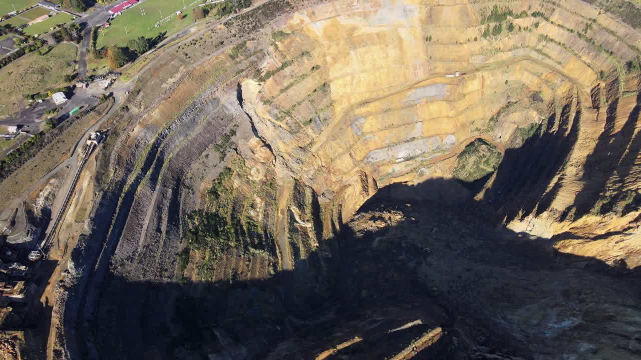 Open gold mine pit aerial look down to slips | Premium Stock Video Footage