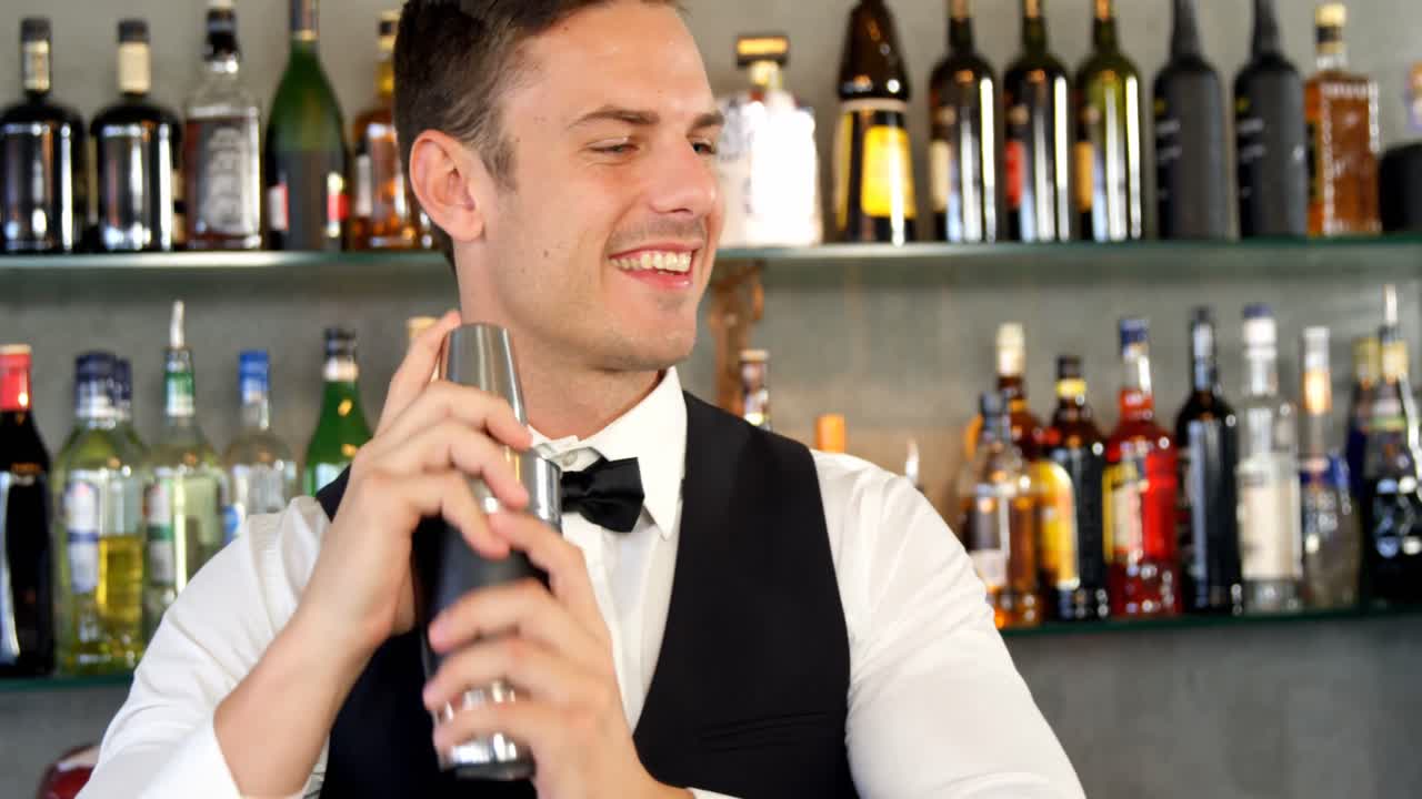 Premium stock video - Waiter shaking cocktail