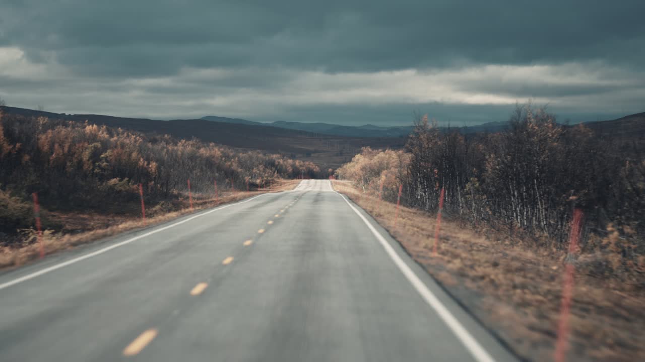 Premium stock video - A narrow asphalt road leading through the pale ...