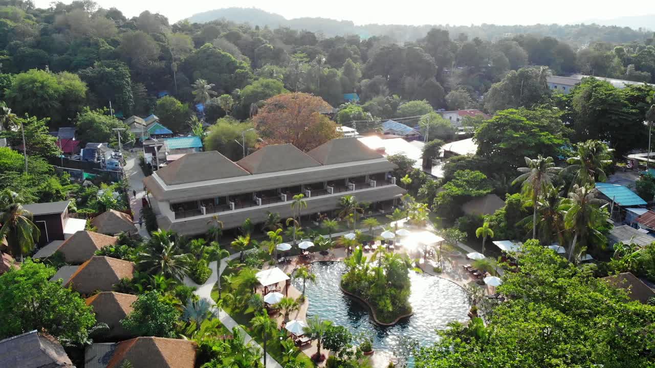 Large luxury tropical resort surrounded by local homes in thailand ...