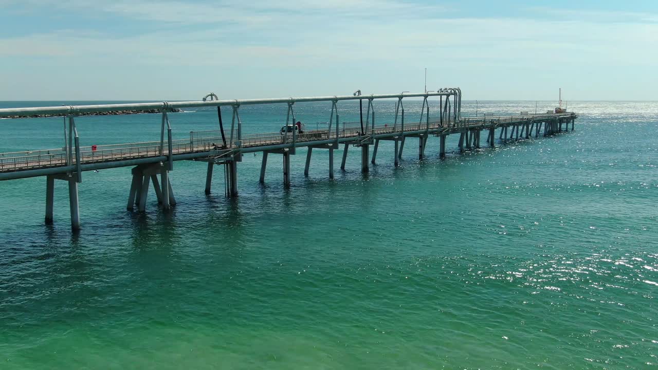 Flying slowly adjacent to the gold coasts sand pumping jetty, the only ...