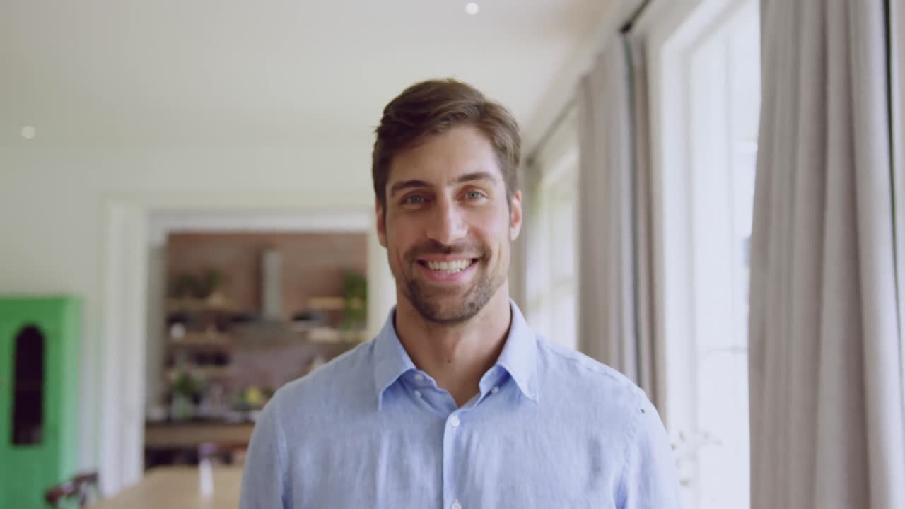 Premium stock video - Man standing in living room at home 4k