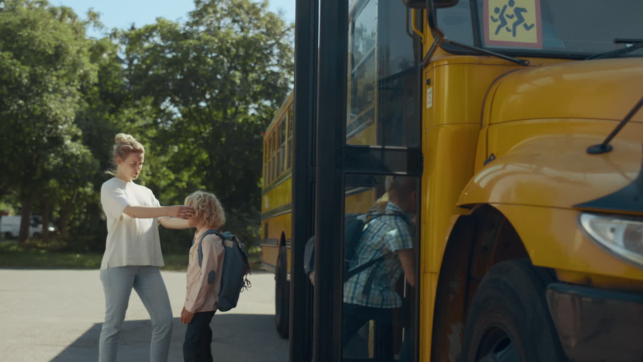Premium stock video - Mother saying goodbye little son standing at bus ...