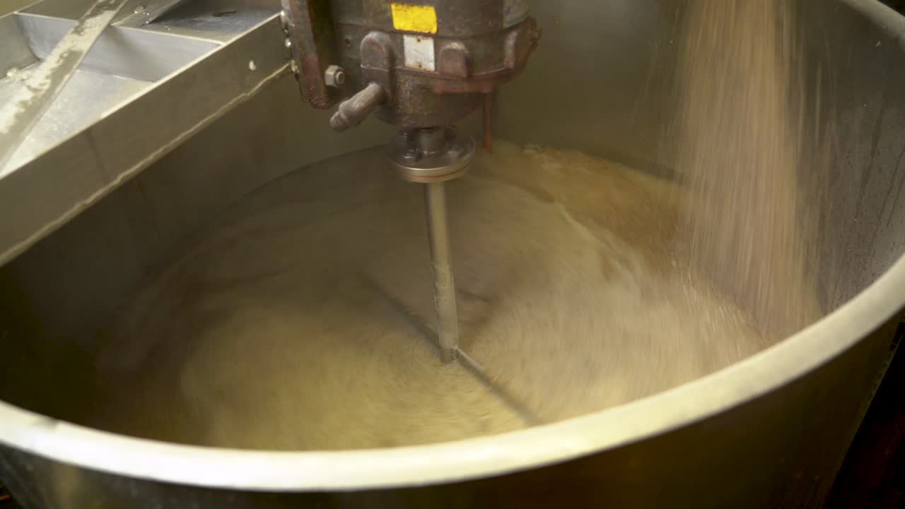 Premium stock video - Mashing the grain and liquor in the mash tun ...