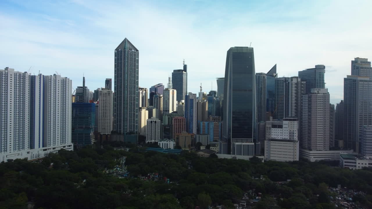 Drone approaching the Makati skyline, partly sunny day in Manila ...