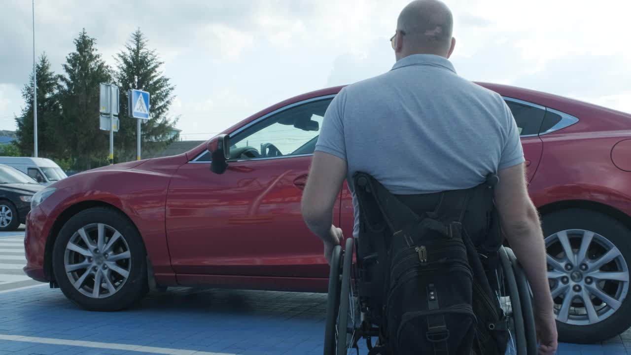 Young handicapped driver getting in red car from wheelchair | Premium ...