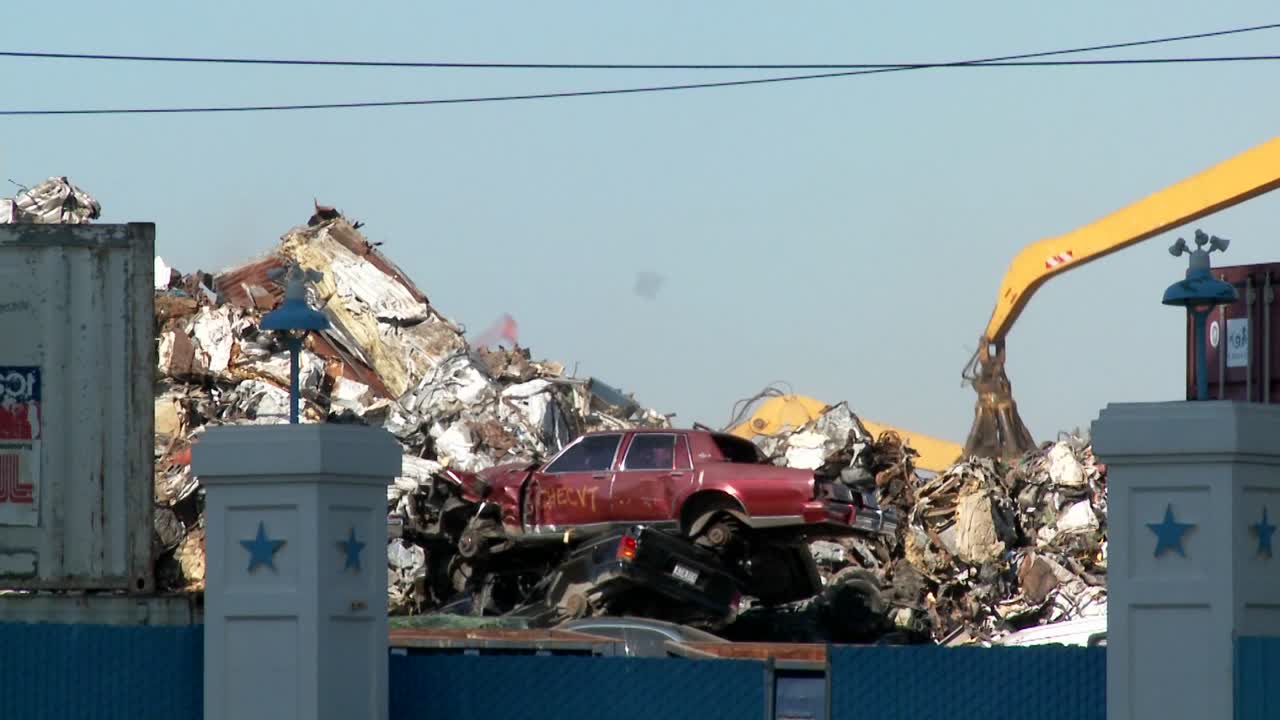 Premium stock video - Cranes lift and move scrap metal around abandoned ...