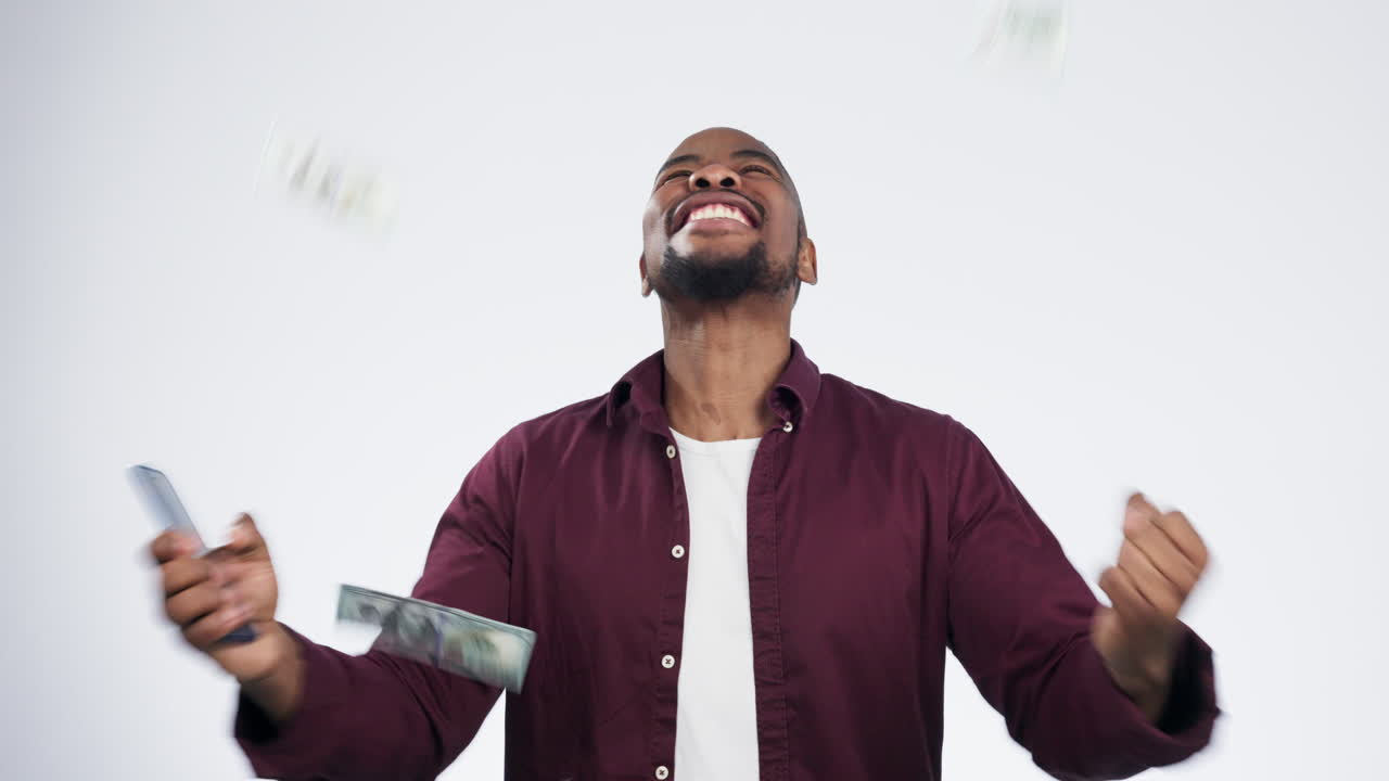 Premium stock video - Lotto, cash and black man winning on a phone