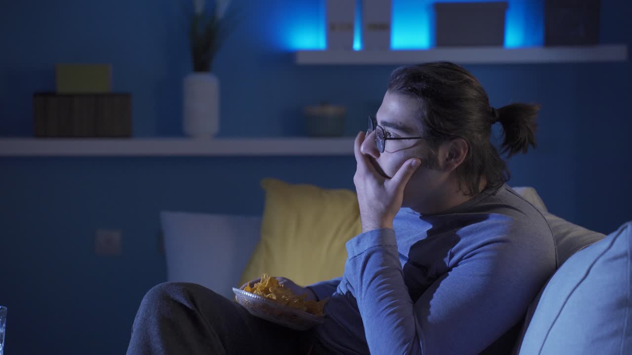 Funny man watching horror movie. Premium Stock Video Footage