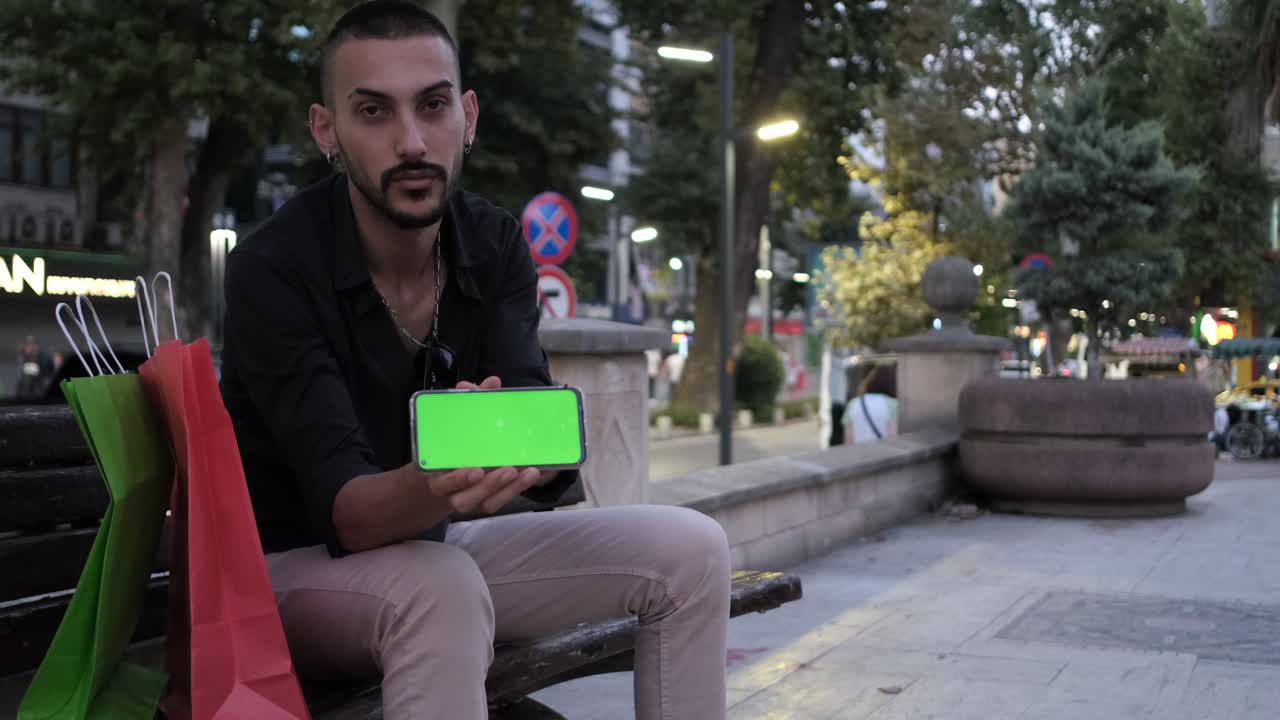 Premium stock video - Man showing greenscreen