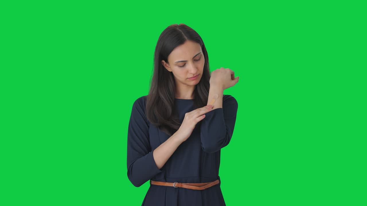 Indian girl putting a bandage on arm Green screen | Premium Stock Video ...