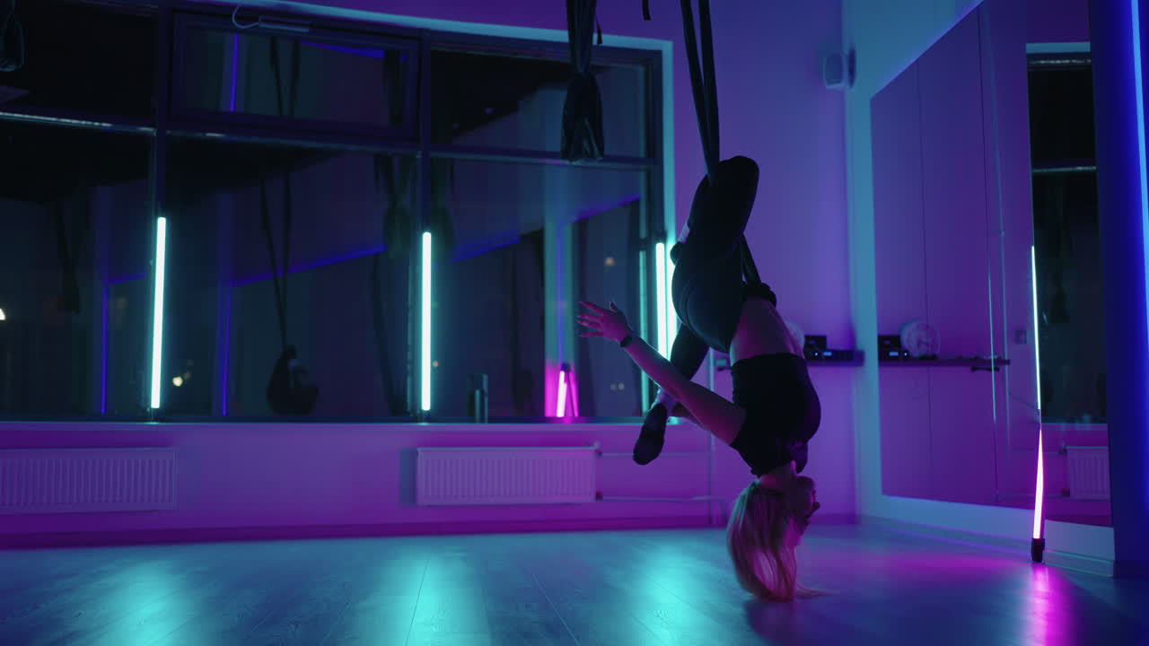 Premium stock video - Woman is training in aerial yoga class swaying in ...