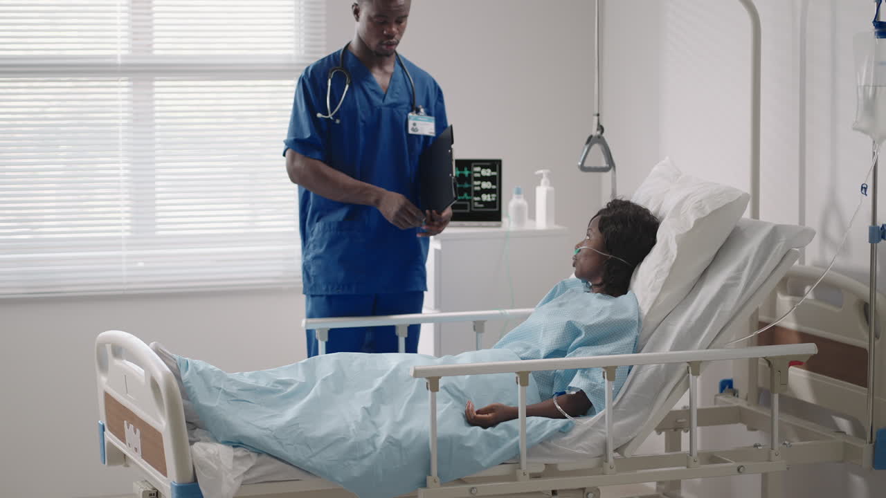 Premium stock video - A black male doctor is talking to a black female ...