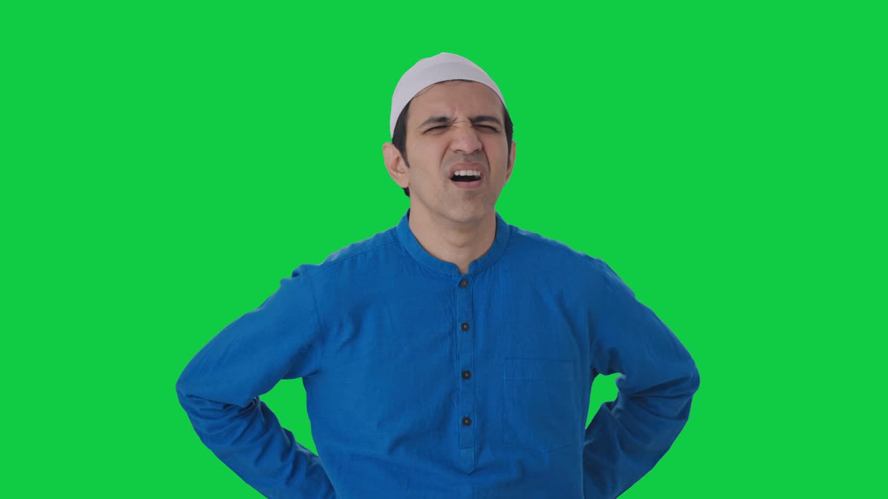 Sick Muslim man suffering from back pain Green screen | Premium Stock ...