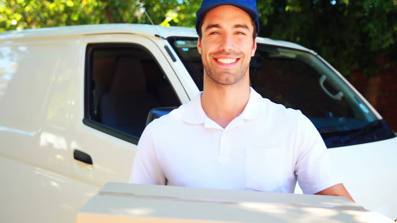 Premium stock video - Delivery man carrying a parcel
