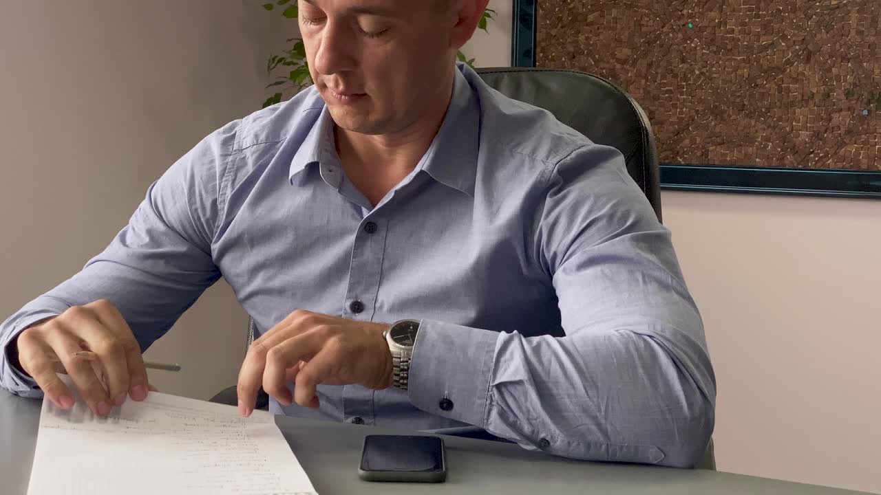 Close up shot of man hands noting something in the note book while ...