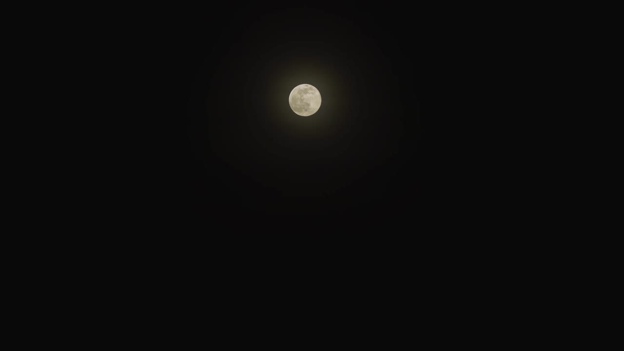 Premium stock video - Small full moon on the dark sky