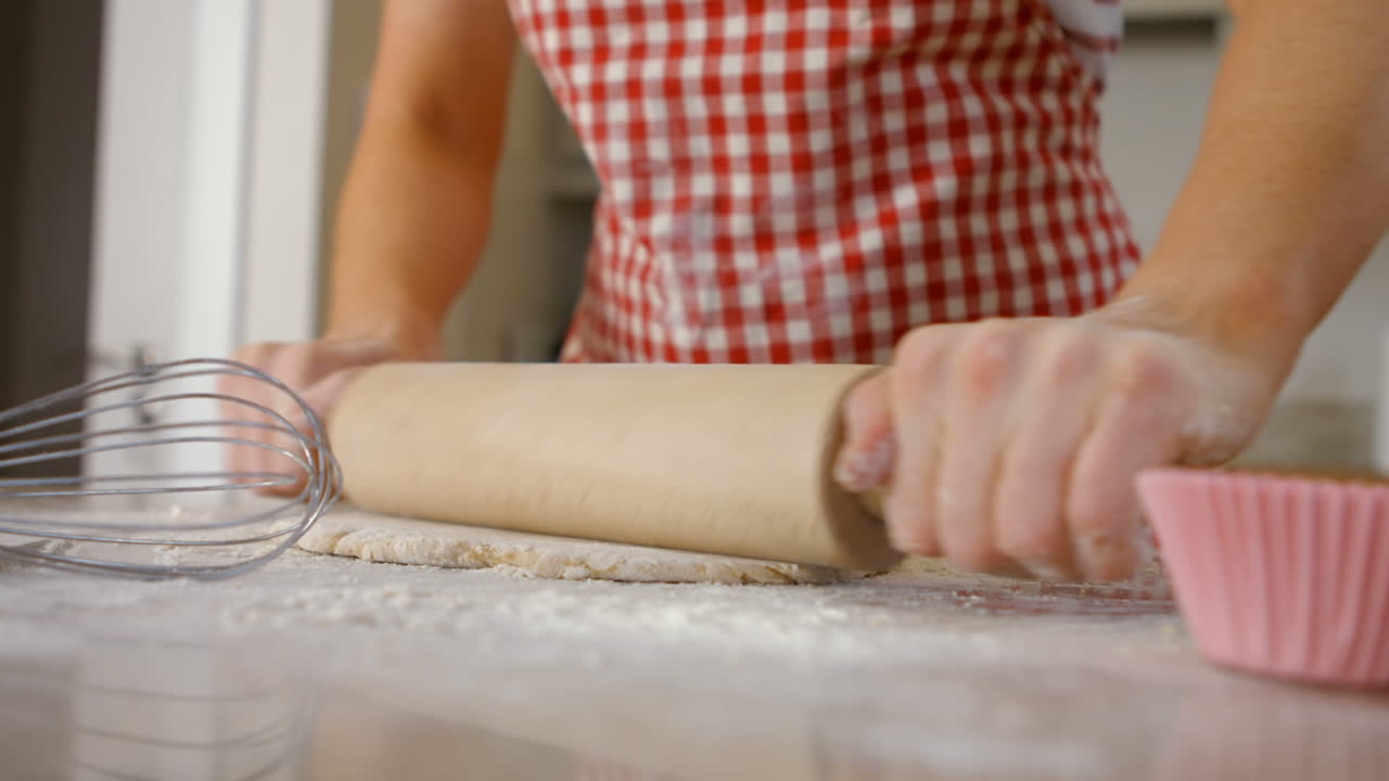 Premium stock video - Woman using rolling pin for baking