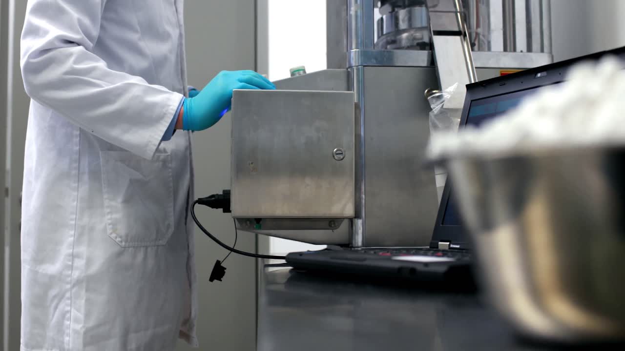 Pharmacist using heavy machinery to make medicine Premium Stock Video ...