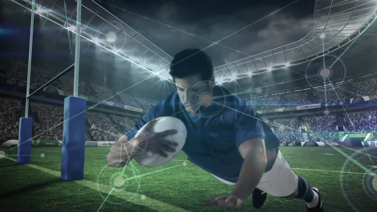 Rugby player diving to score in a big stadium with light connections on ...