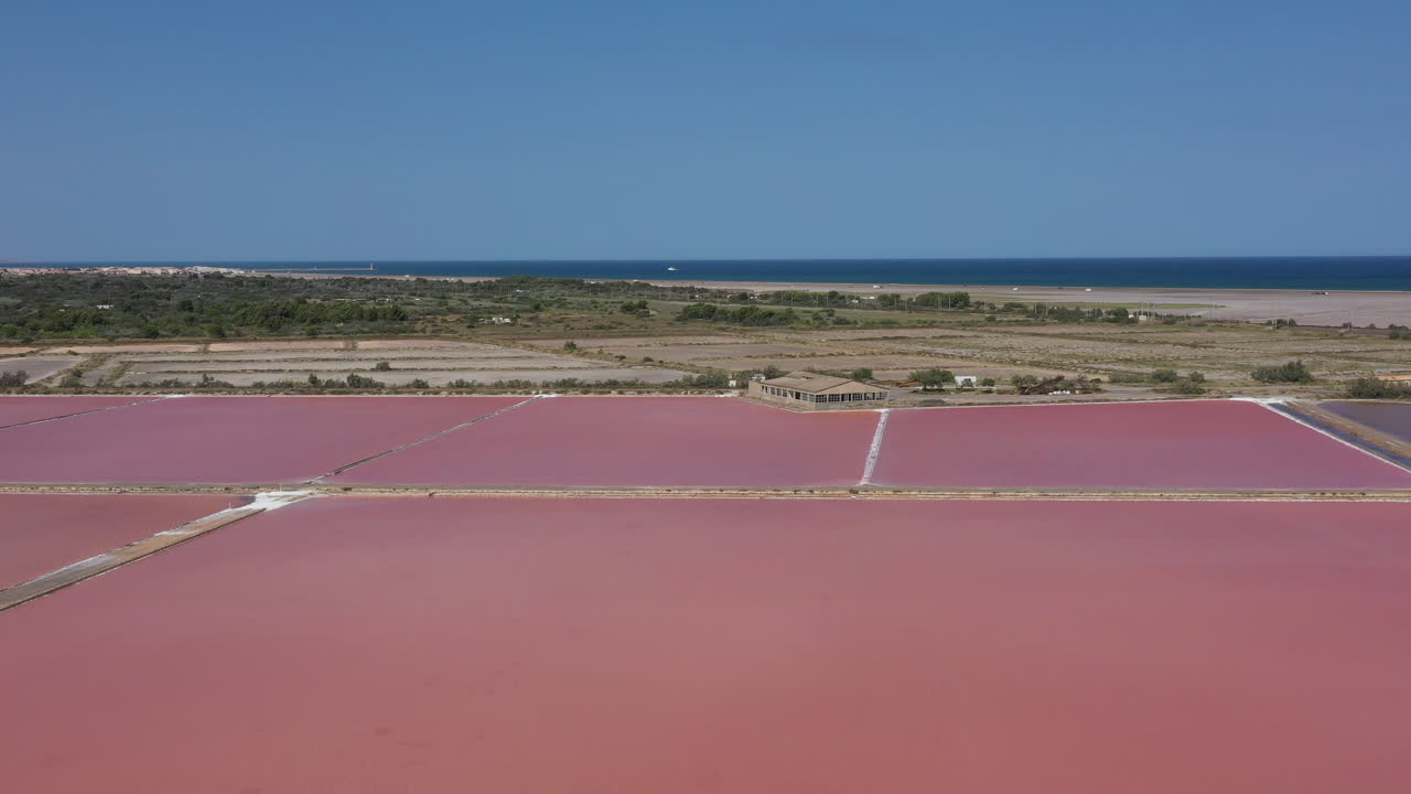 Sand mediterranean sea and pink salt marshes salin de la Palme aerial ...
