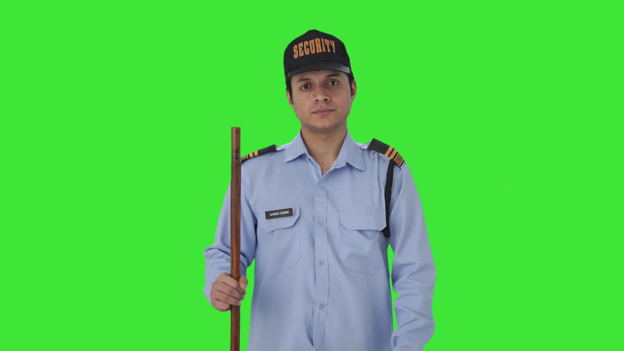 Confident indian security guard looking at the camera green screen ...