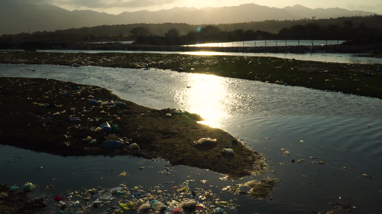 Polluted Area With Sunset Water Reflection And Plastic Waste Toxic ...