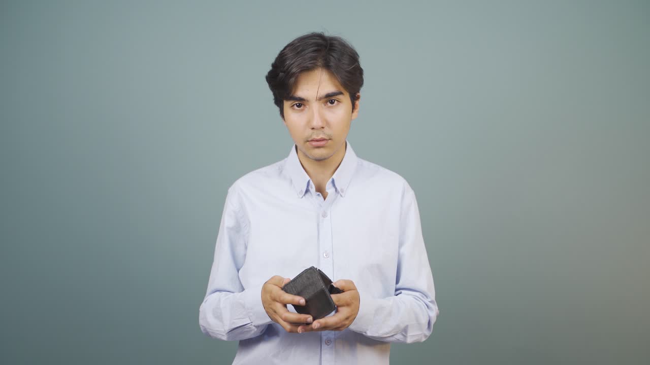 Penniless man looking at his empty wallet. Premium Stock Video Footage