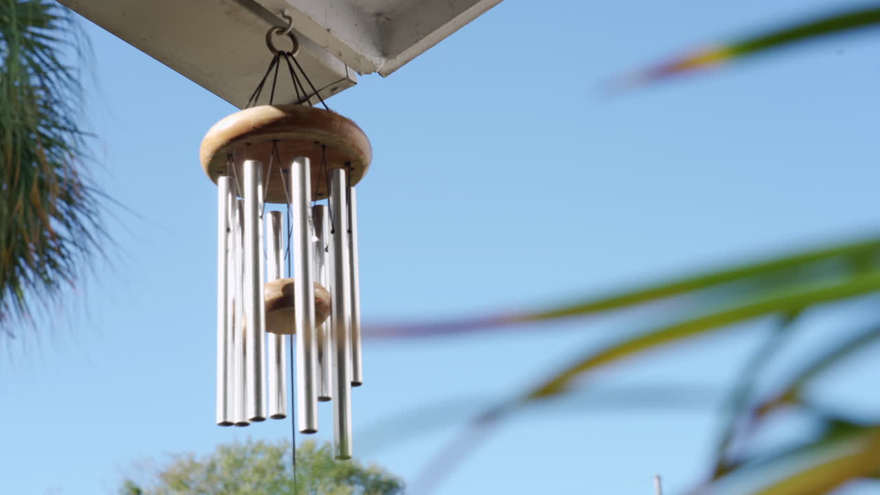 Calming And Relaxing View Of A Wind Chime Blowing In A Tropical Garden ...