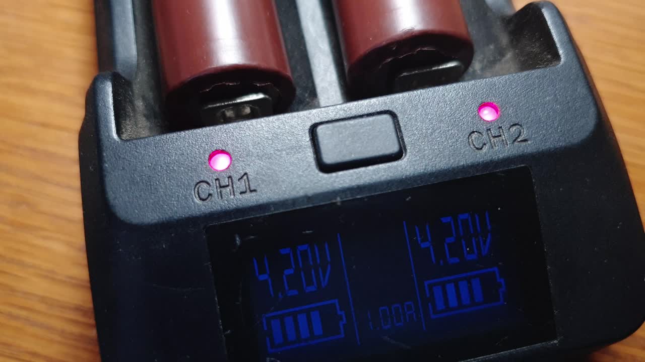 Premium stock video - Lithium ion two bay battery charging cells, lcd ...