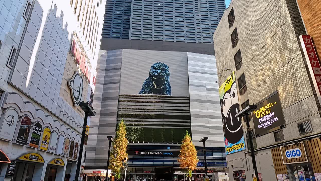 Premium stock video - Toho cinema with big godzilla in the streets of shinjuku kabukicho