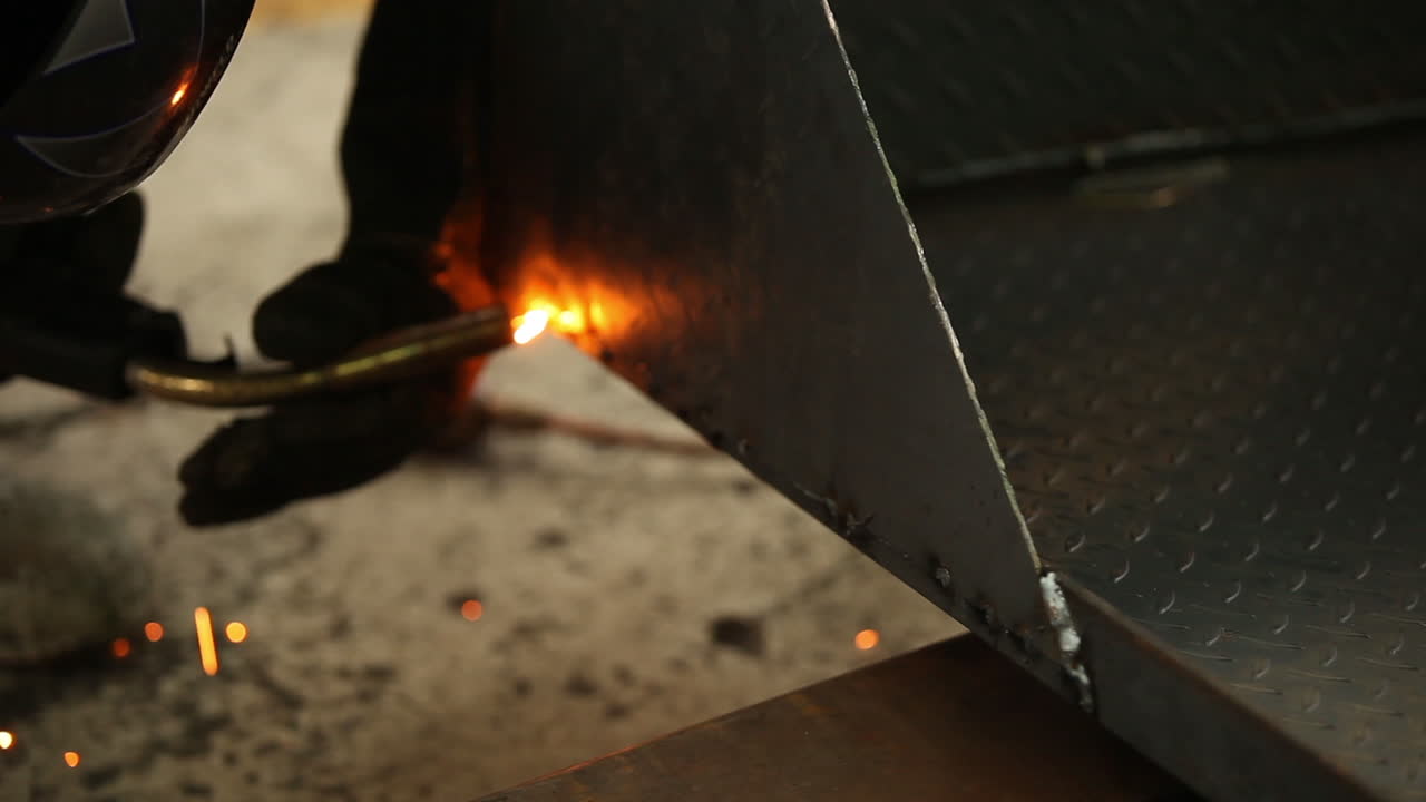 Premium stock video - Welder working on a small specific area of heavy ...