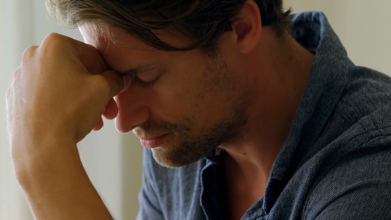 Premium stock video - Worried man relaxing at home 4k