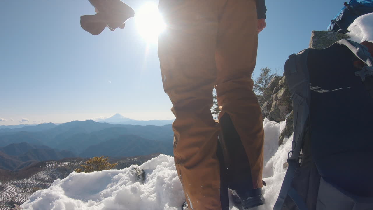 Premium stock video - A man boiling water in a winter mountain