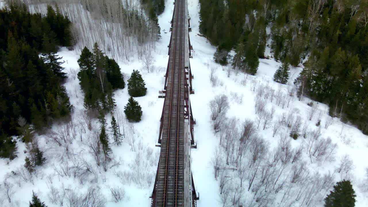 Premium stock video - Drone flight over a train bridge in the winter ...