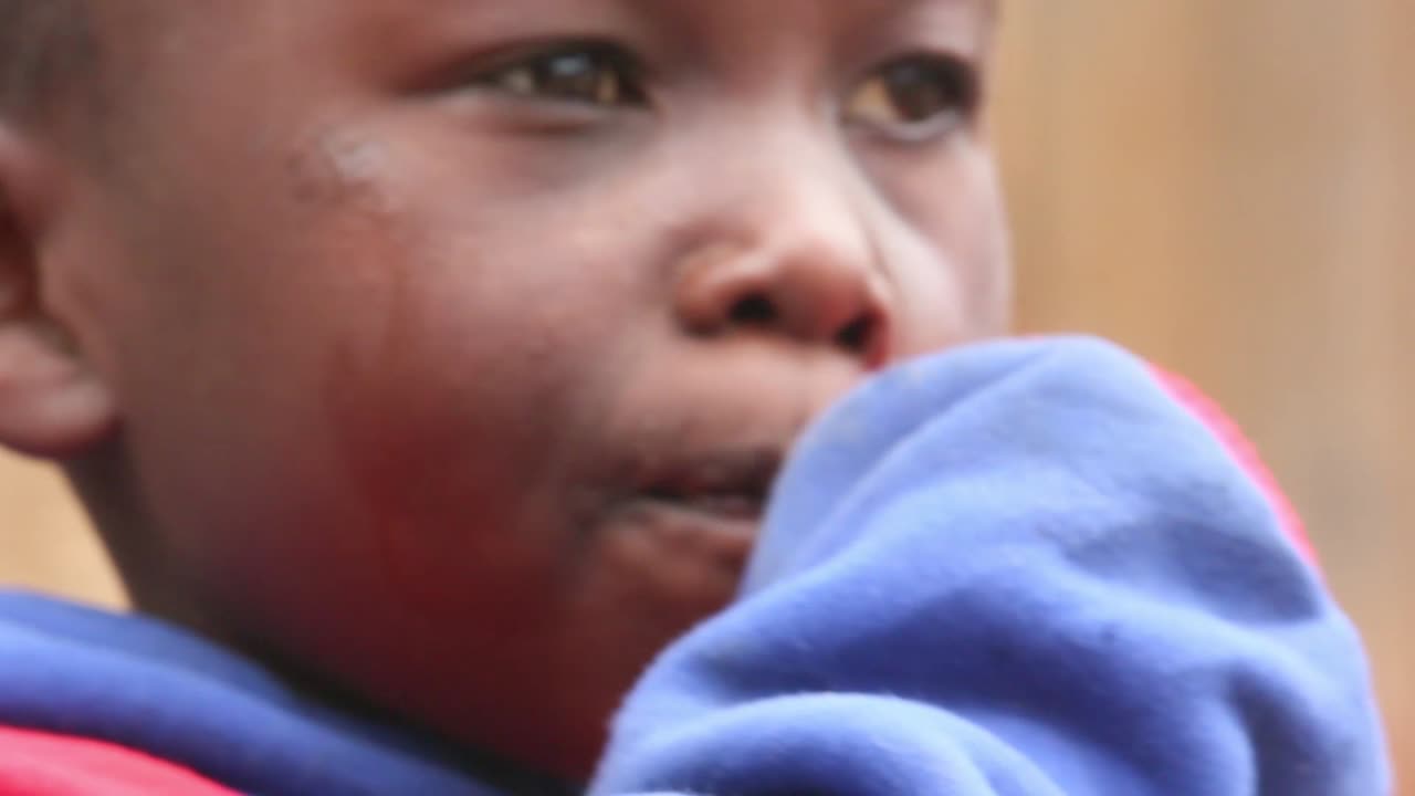 Premium stock video - A kid crying and showing tears on her cheeck