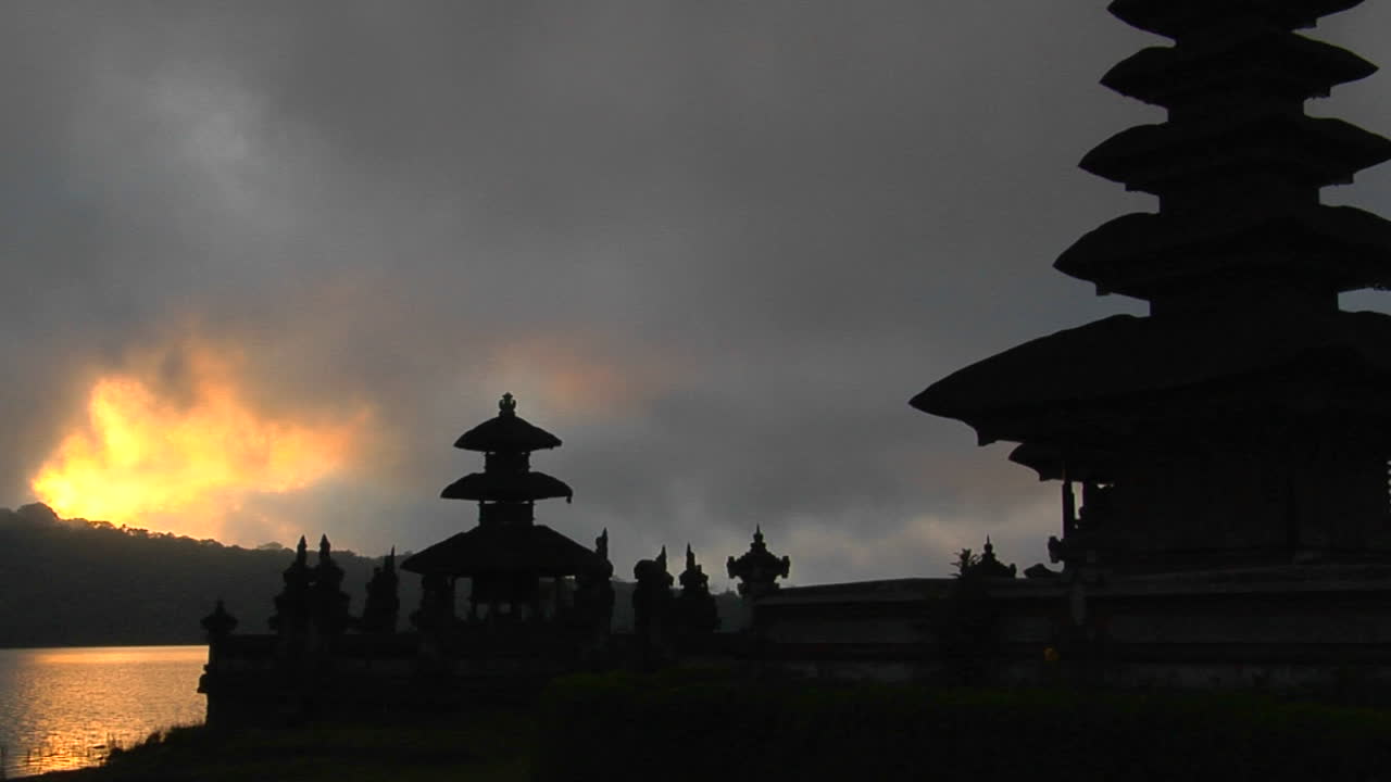 Premium stock video - A balinese temple overlooks reflections in a lake 2