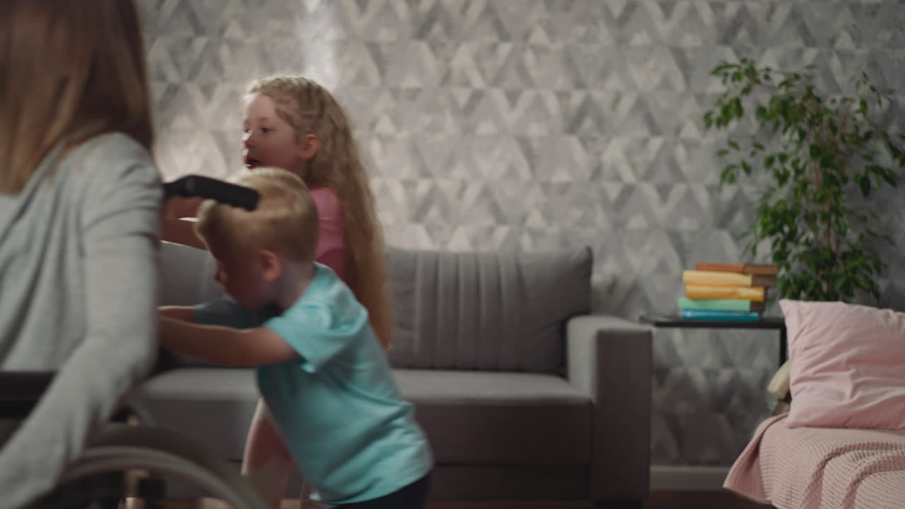 Premium stock video - Caring siblings help mom with disability to push ...