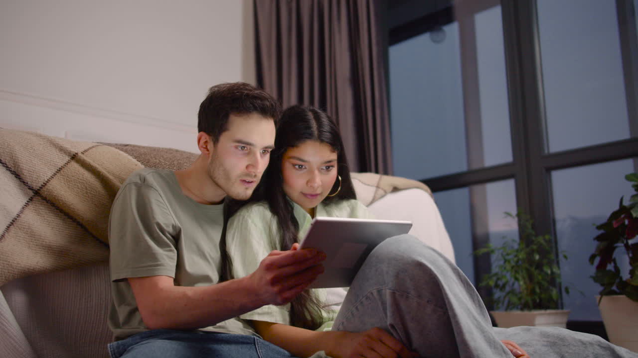 Bottom View Of Couple Watching Interesting Movie On Tablet While ...