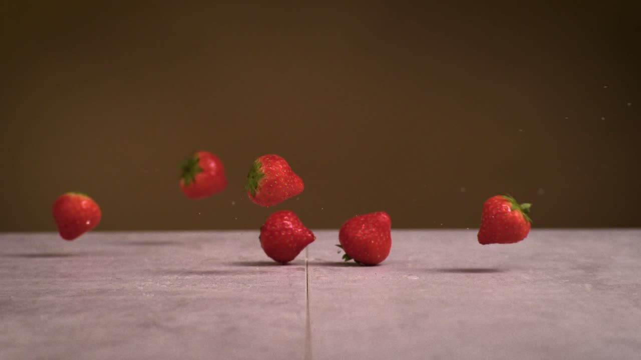 Strawberries Falling On Surface And Water Splashes Everywhere In Super ...