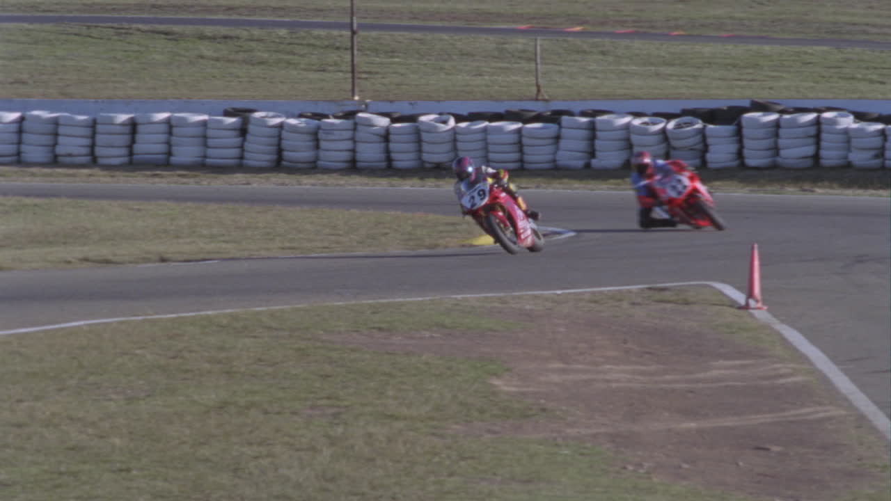 Premium stock video - Motorcyclists race around a track 3