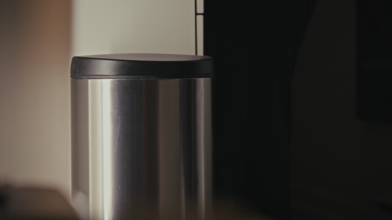 Throwing trash into bin in slow motion, focusing on waste and motion ...