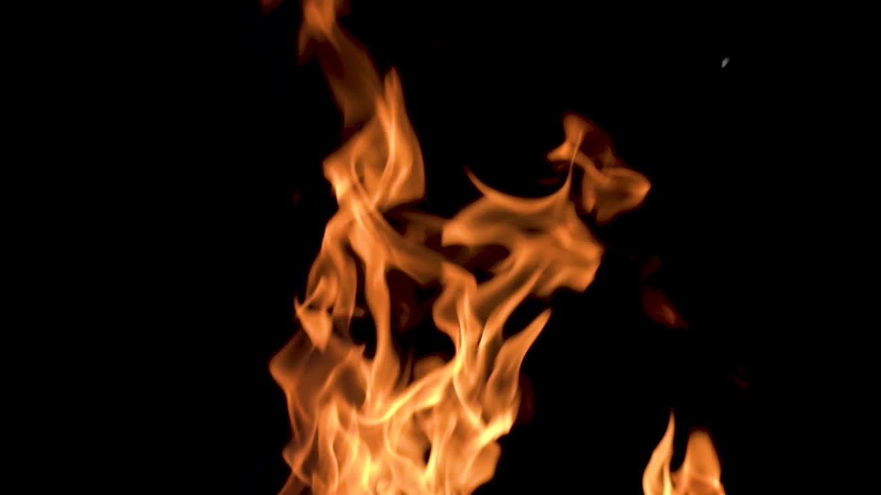 Slow motion shot of fire on a black background to use it transparent in ...